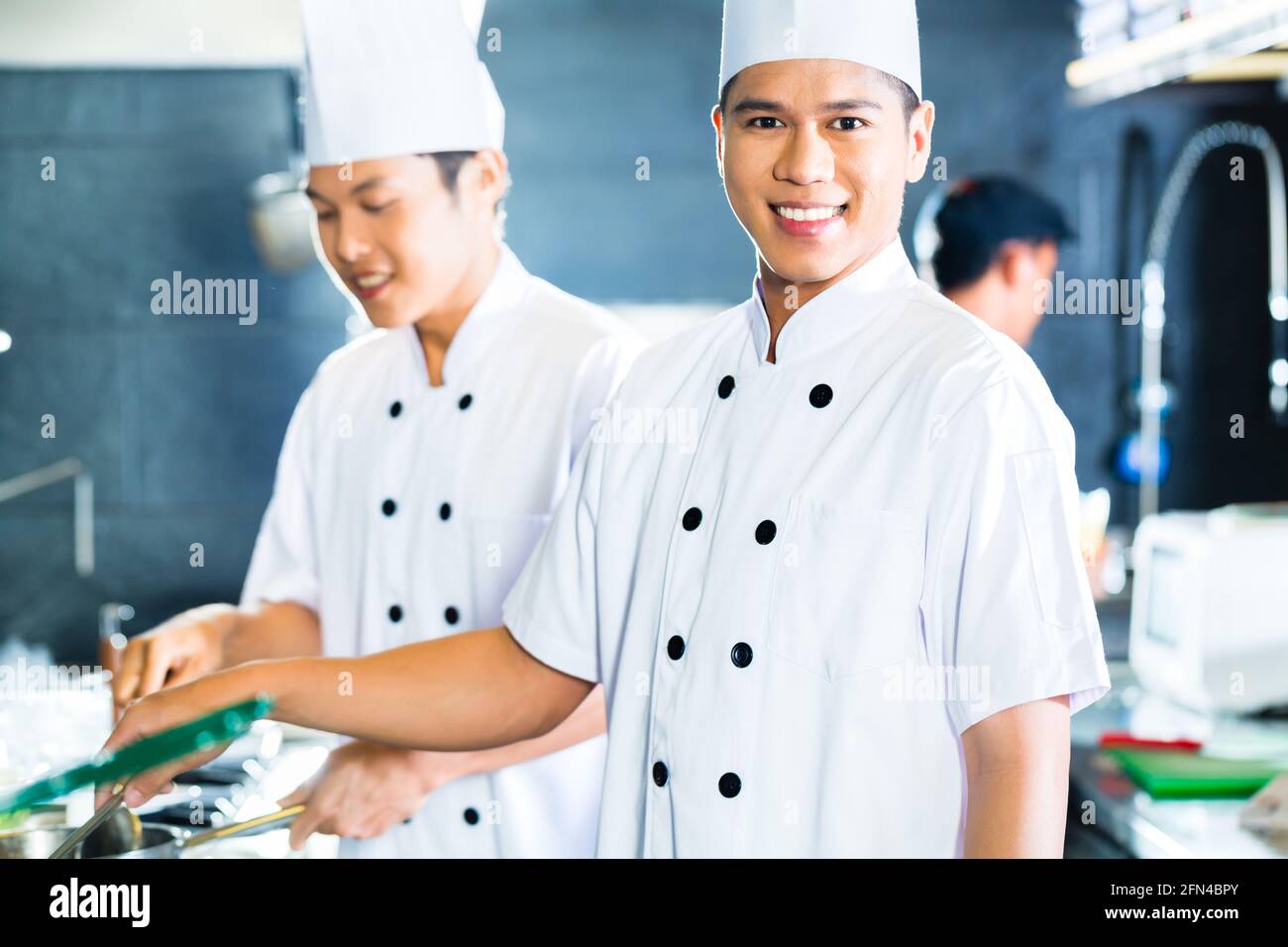 Portrait of young chefs cooking together Stock Photo - Alamy