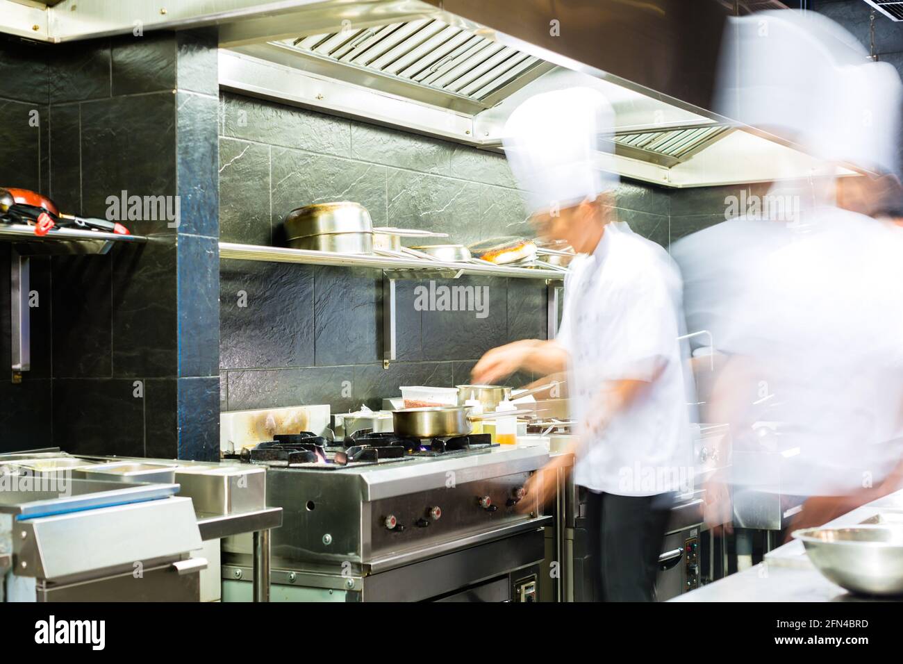 Chef cooking in the kitchen of a restaurant Stock Photo - Alamy