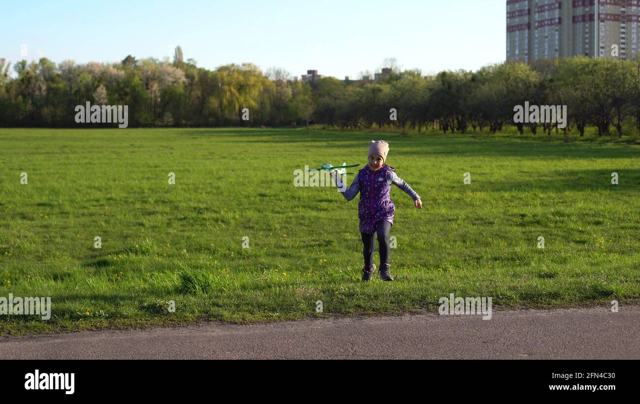 little girl with toy airplane in hands outdoor, screw wind-stick of ...