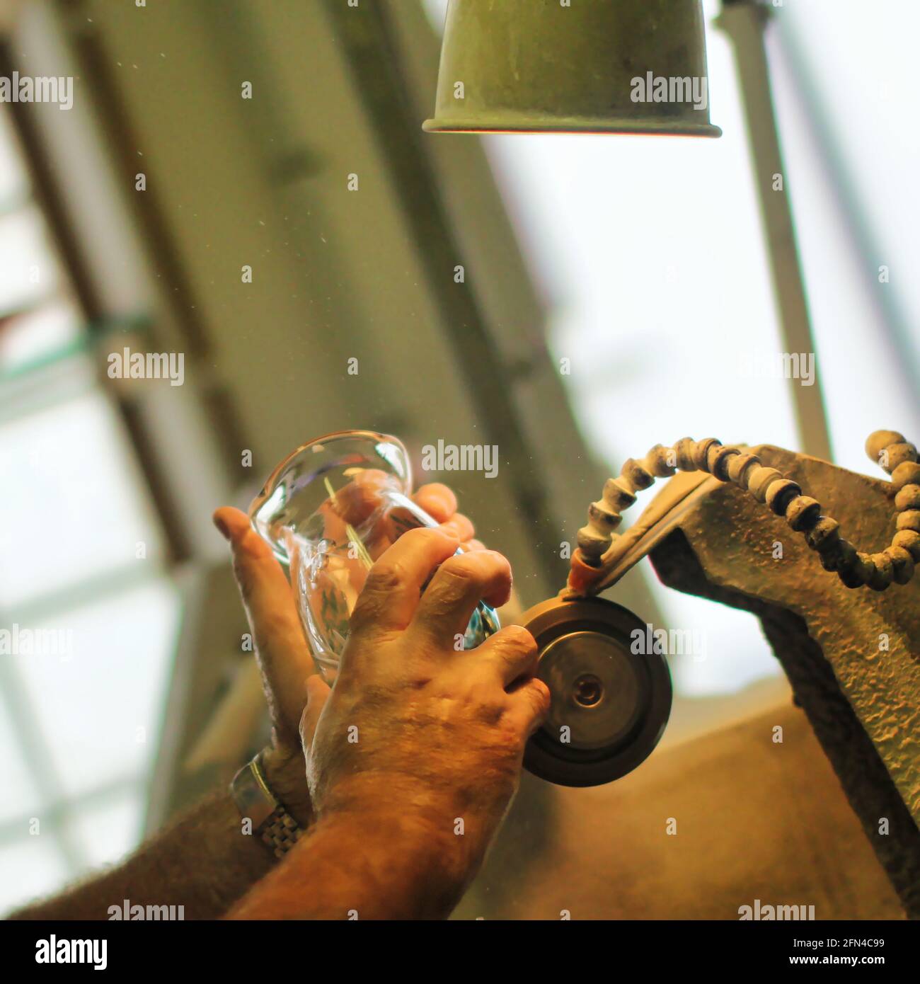 Hands of glassmaker creating glass sculptures. Factory work and crafts ...