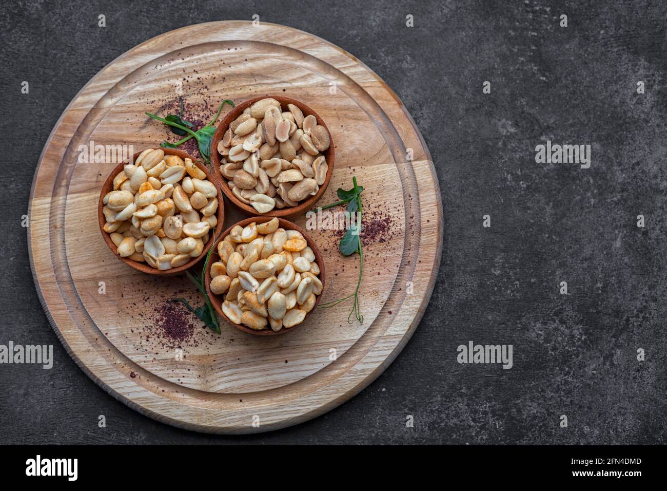 Roasted peanuts for beer, on a dark background Stock Photo - Alamy