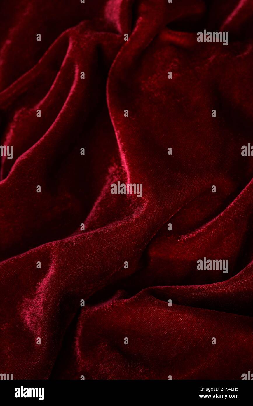Close up of crumpled colourful crumpled crimson red velvet revealing it ...