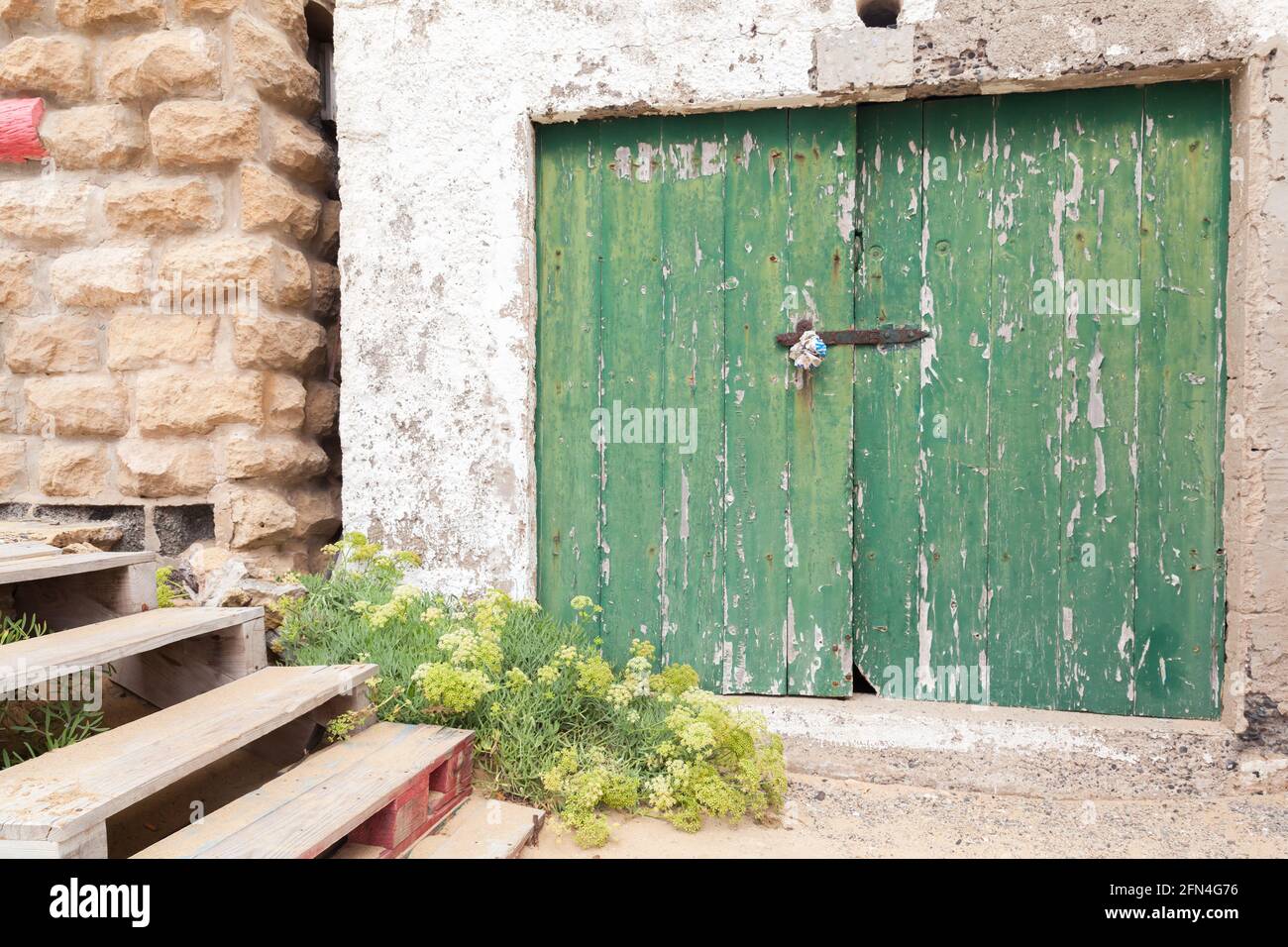 Green wooden gate of a coastal barn for boats. Porto Santo island in ...