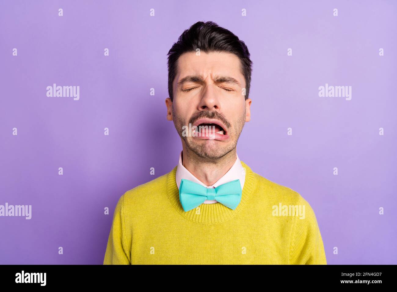 Portrait of brunet crying guy wear yellow sweater isolated on pastel ...