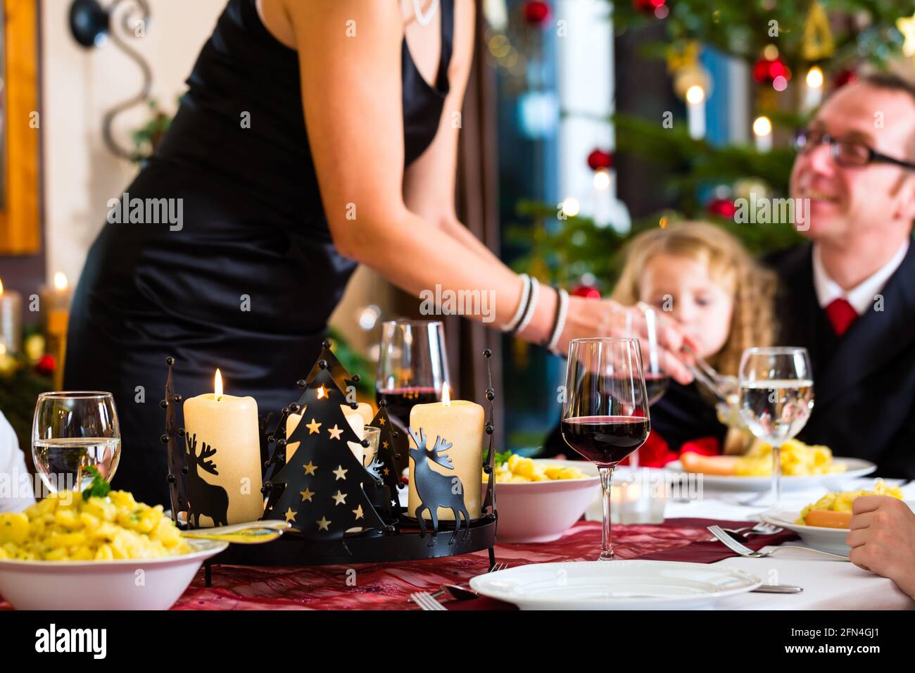 Family of Mother, father, children celebrating Christmas eve with ...