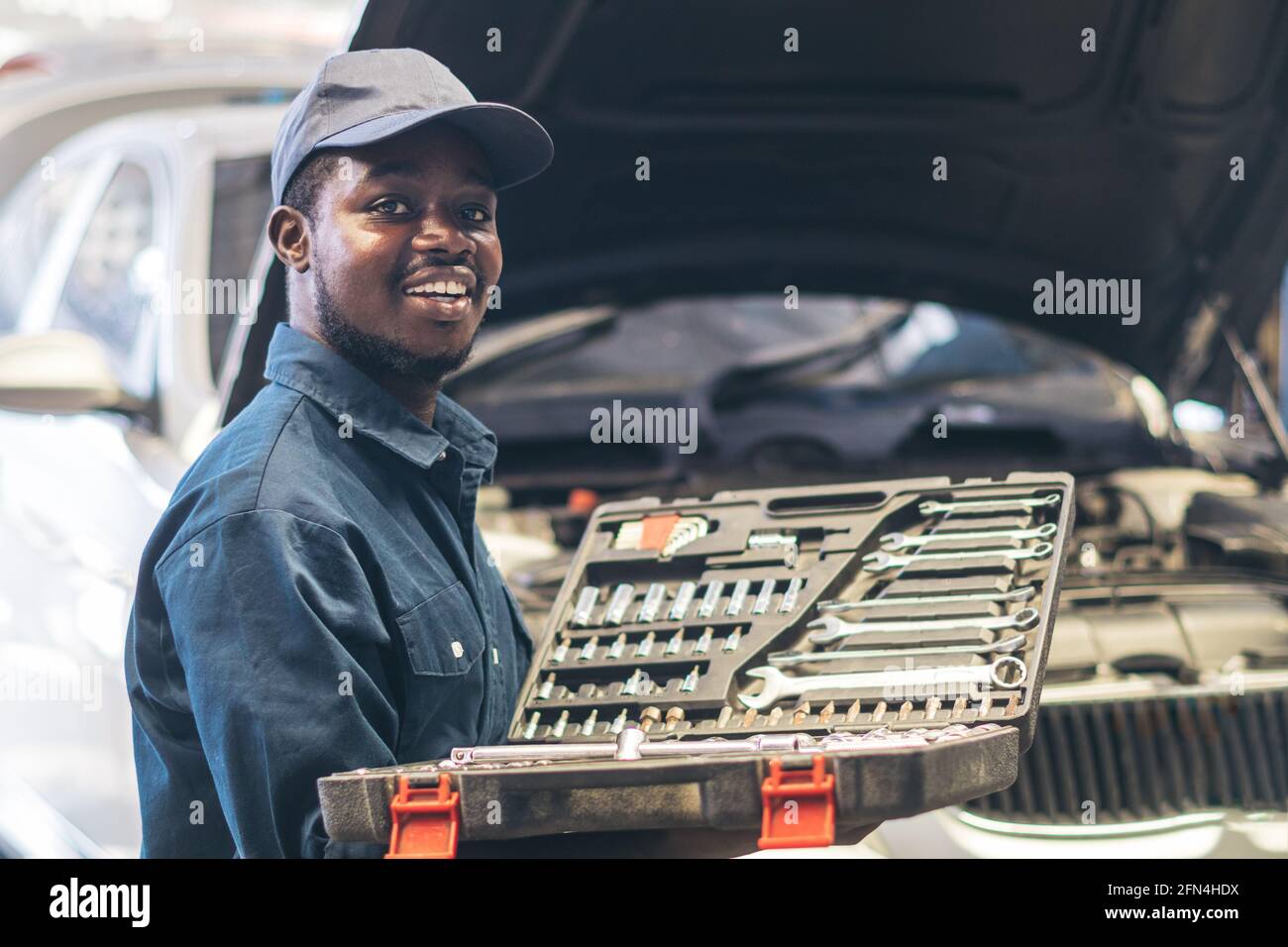 African maintenance male holding a set of car repair tools in box Stock ...