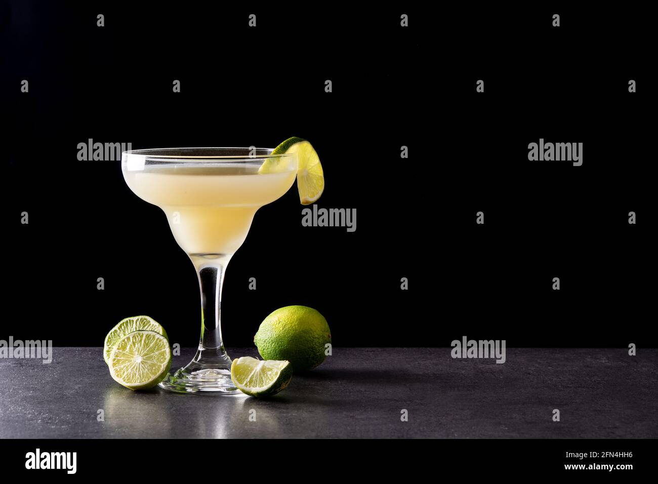 Classic daiquiri cocktail in glass on black background Stock Photo - Alamy