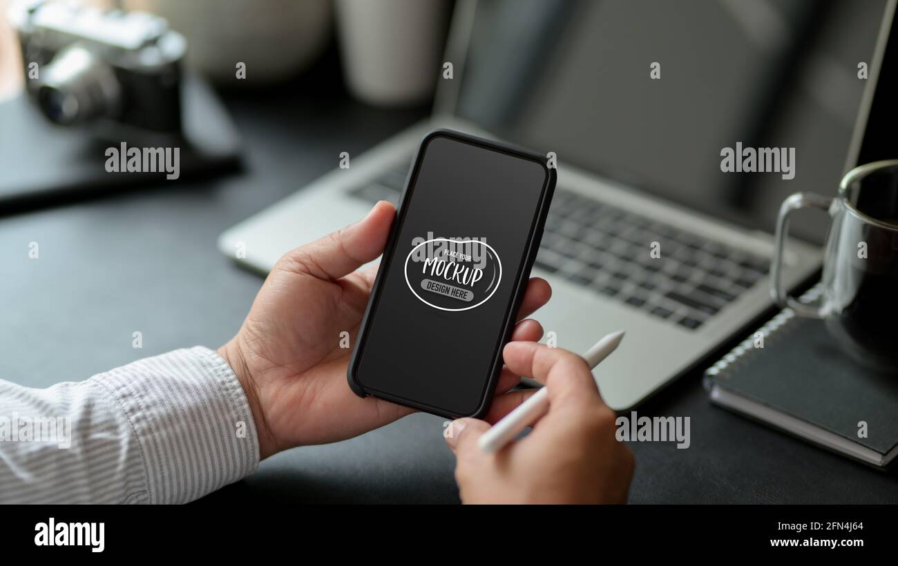 Close up view of male using mock up smartphone while sitting at ...