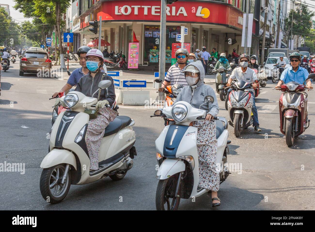 Vietnamese females driving scooters in busy traffic, Da Nang, Vietnam ...