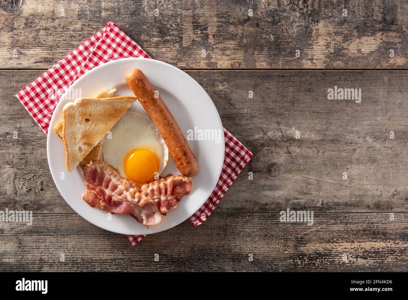Traditional American breakfast with fried egg,toast,bacon and sausage ...