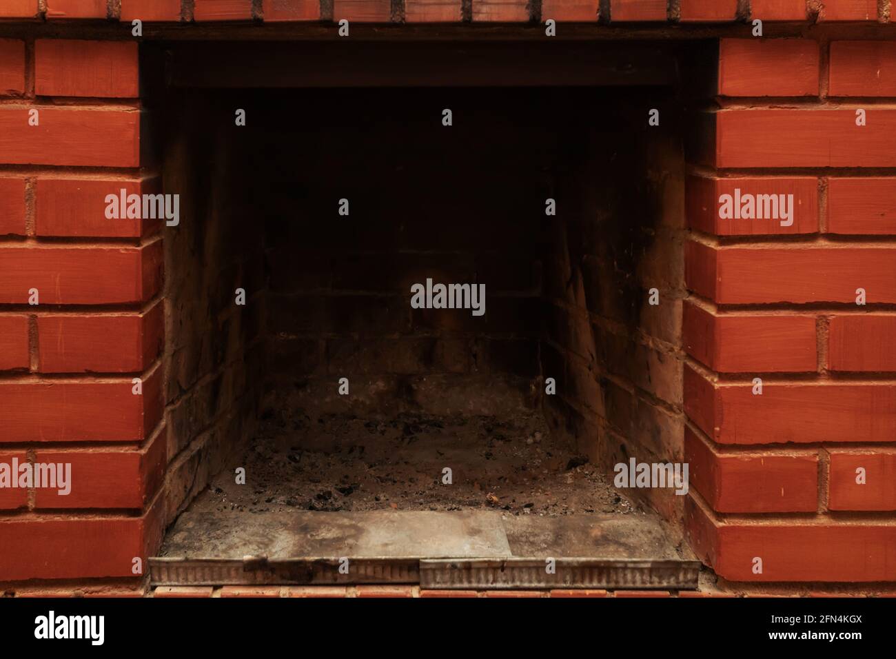 Red brick dirty fireplace with remains of ash after wooden firewood ...
