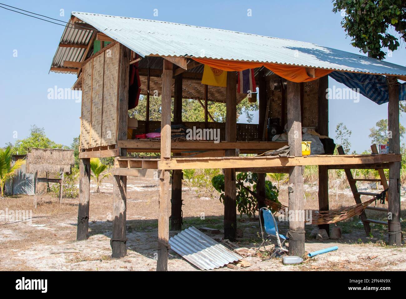 Traditional wooden Thai house elevated on stilts with corrugated iron ...