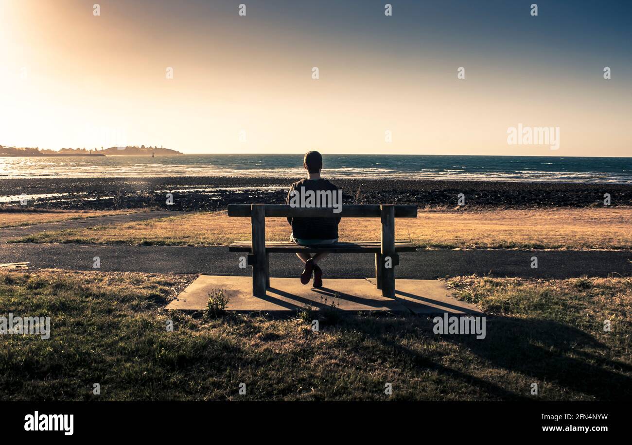 Man Sitting On Bench At Sunset High Resolution Stock Photography and ...
