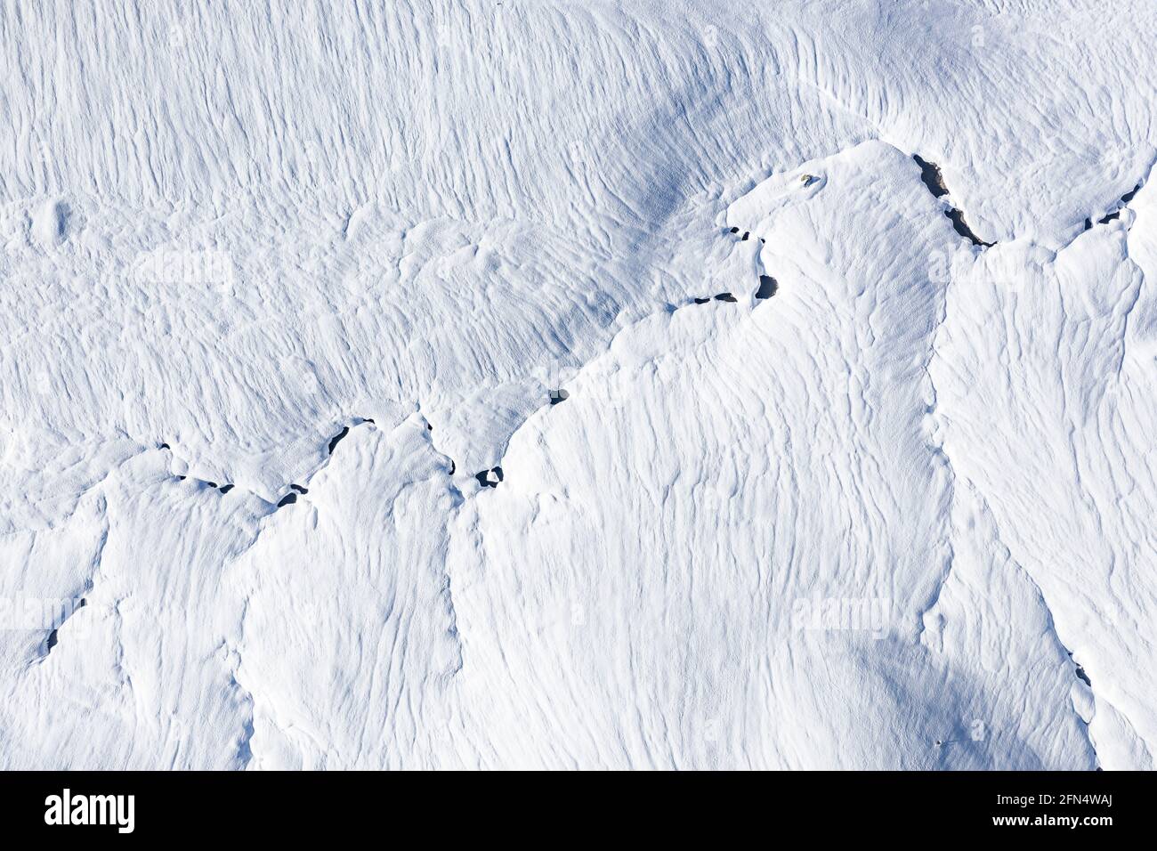 Aerial view of the snowy Pla de Beret in winter. Meanders of the ...