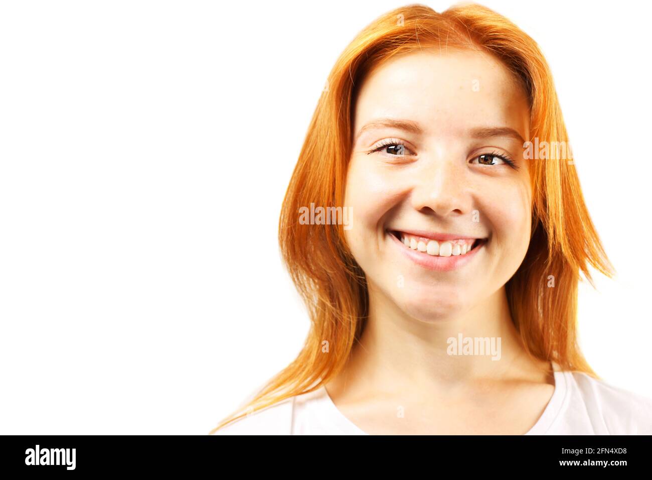 Beautiful redheaded young woman with satisfied facial expression ...