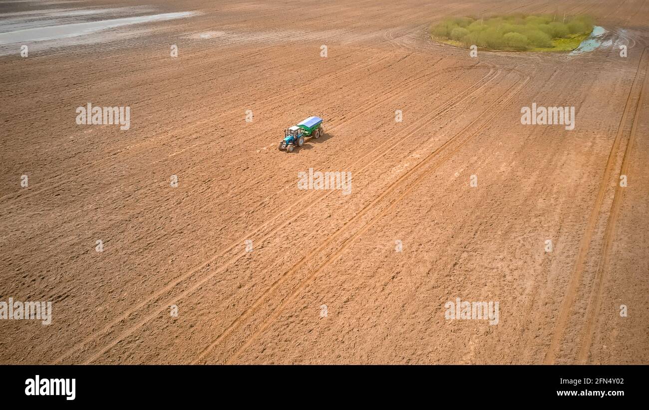 Photo from a tractor drone sowing seeds in a field. Process of planting ...