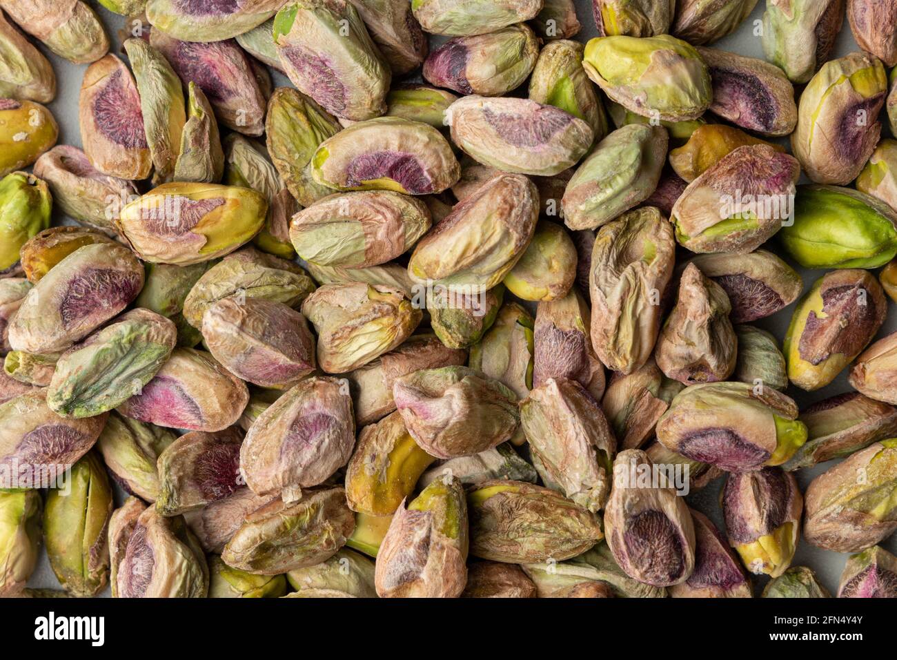 Pile of peeled pistachios as background. Pistachios texture Stock Photo ...