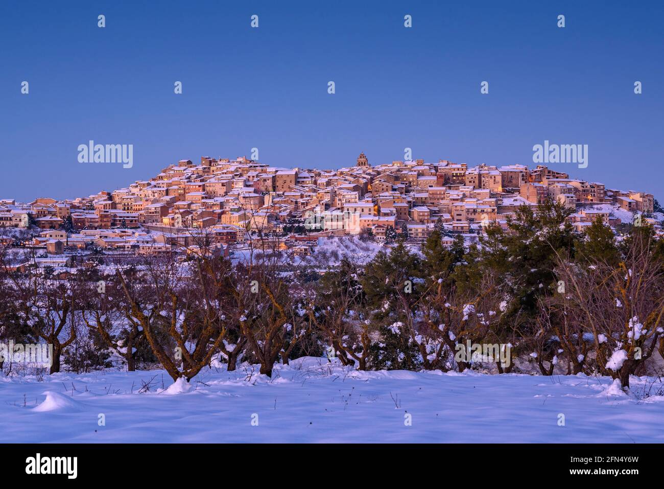 Horta de Sant Joan village, in a winter snowy twilight - blue hour ...