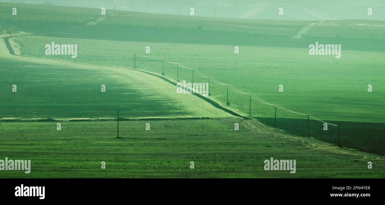 Beautiful panoramic view moravian fields with green grass and electric ...