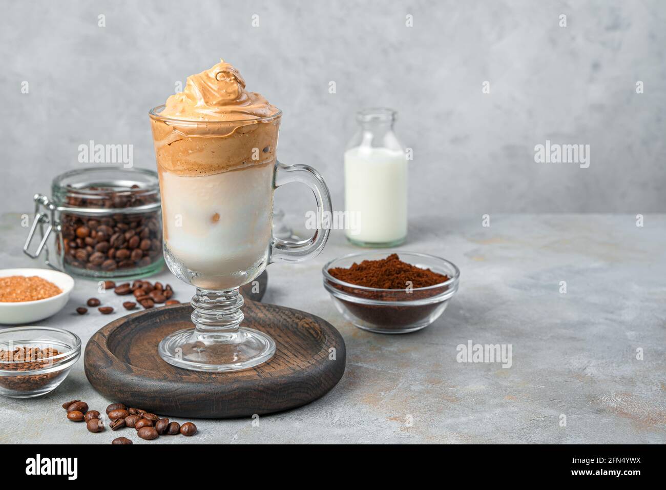 Dalgona iced coffee on a gray vintage background. Coffee foam with milk ...