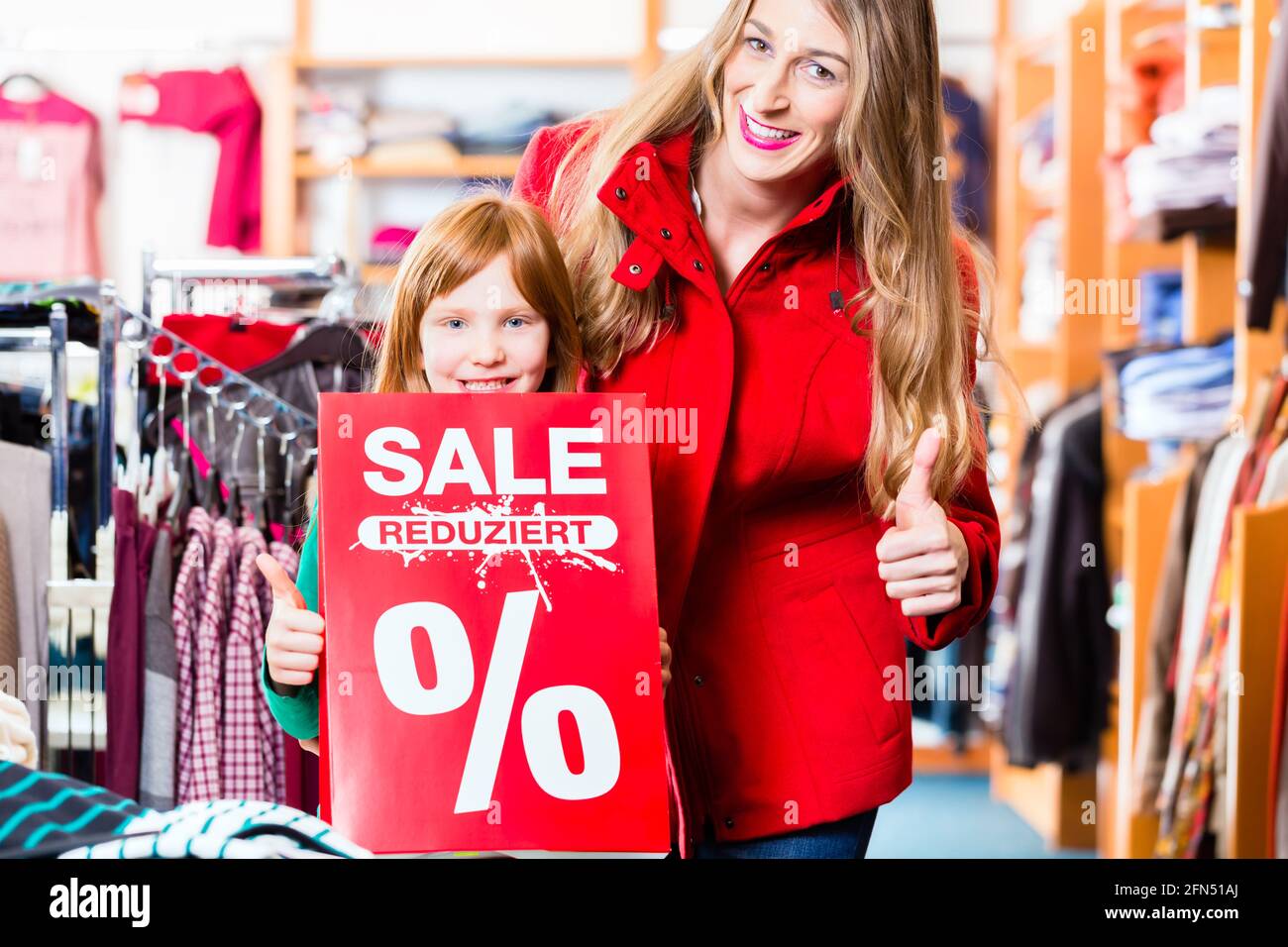 Smiling little girl promoting sale offer in shopping mall Stock Photo ...