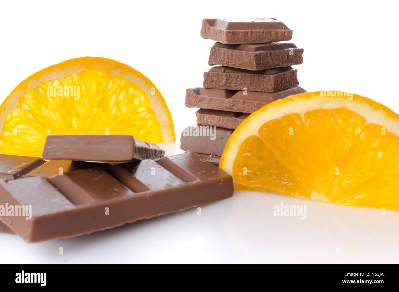 Chocolate squares with fresh orange slices, isolated on white Stock ...