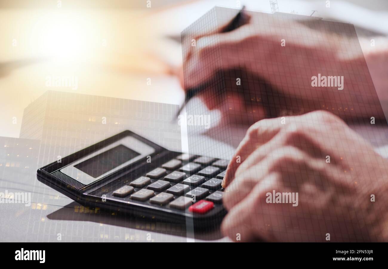Male hand using calculator, accounting concept, light effect, double ...