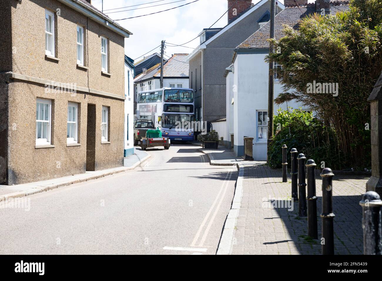 Double Decker Bus travels through a narrow gap in Marazion, Cornwall ...