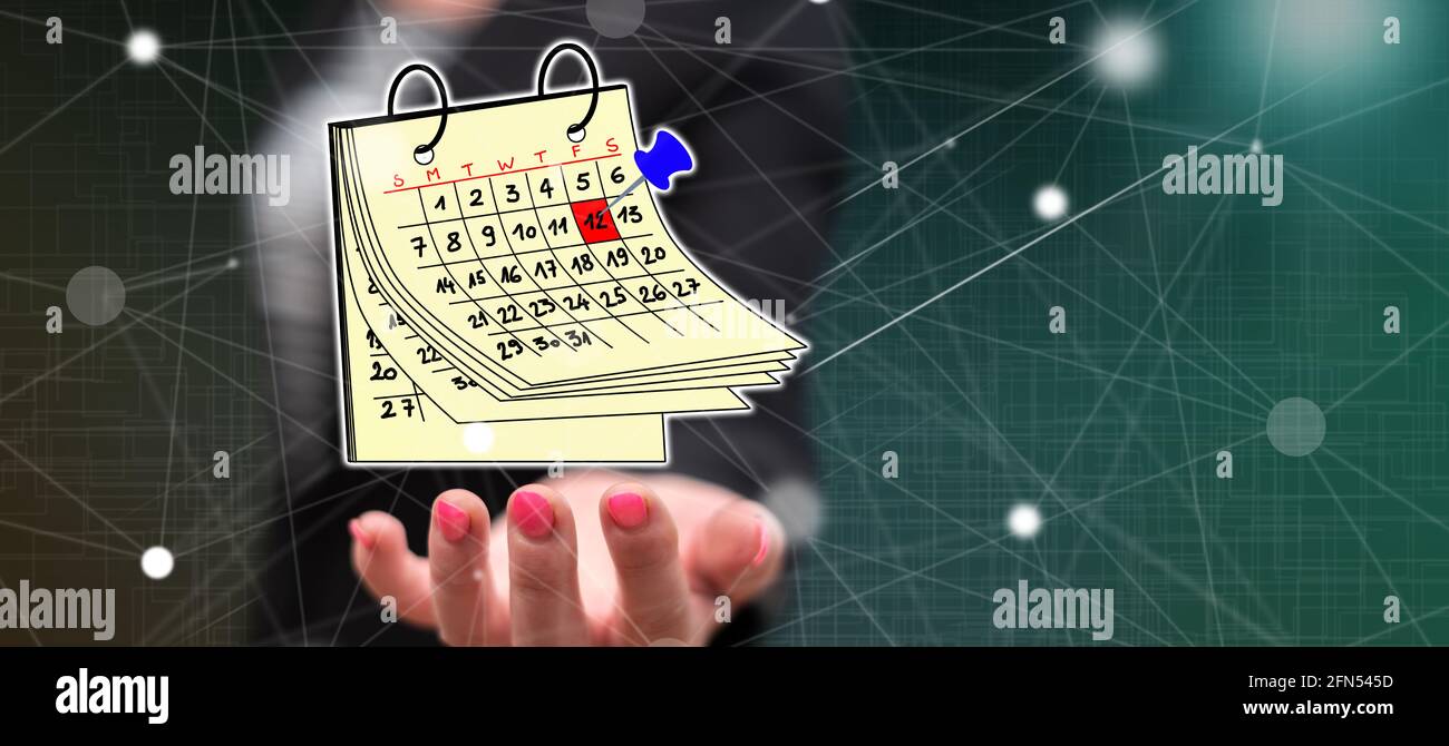 Calendar concept above the hand of a woman in background Stock Photo ...