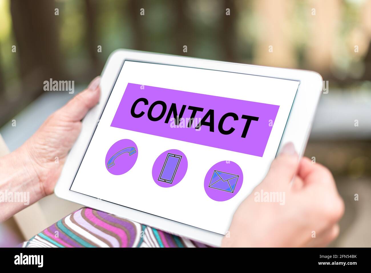 Female hands holding a tablet with contact concept Stock Photo - Alamy