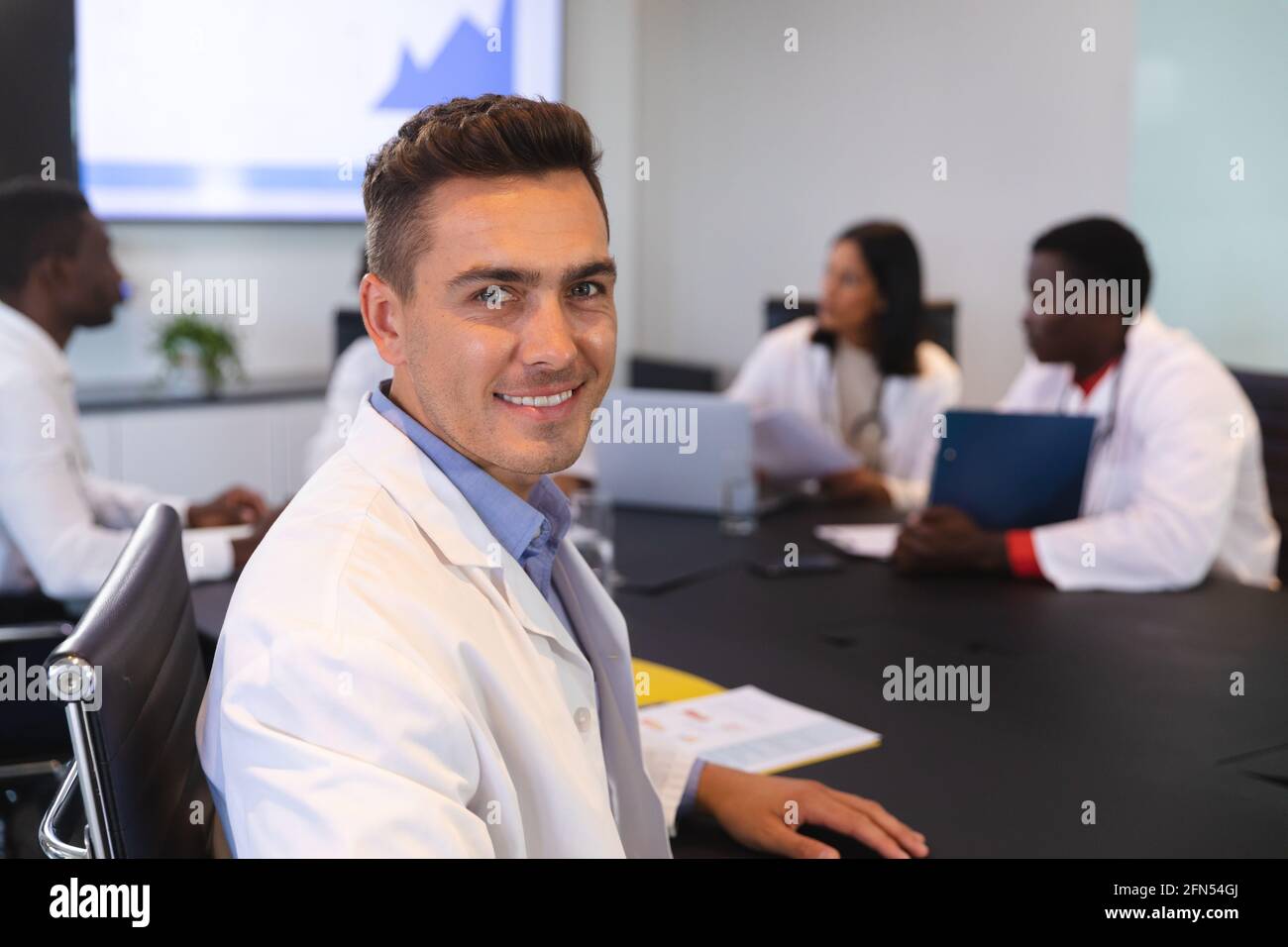Male doctor sitting on chair hi-res stock photography and images - Alamy