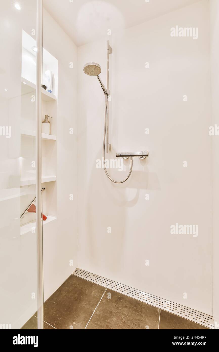 Shower tap in tiled bathroom Stock Photo - Alamy