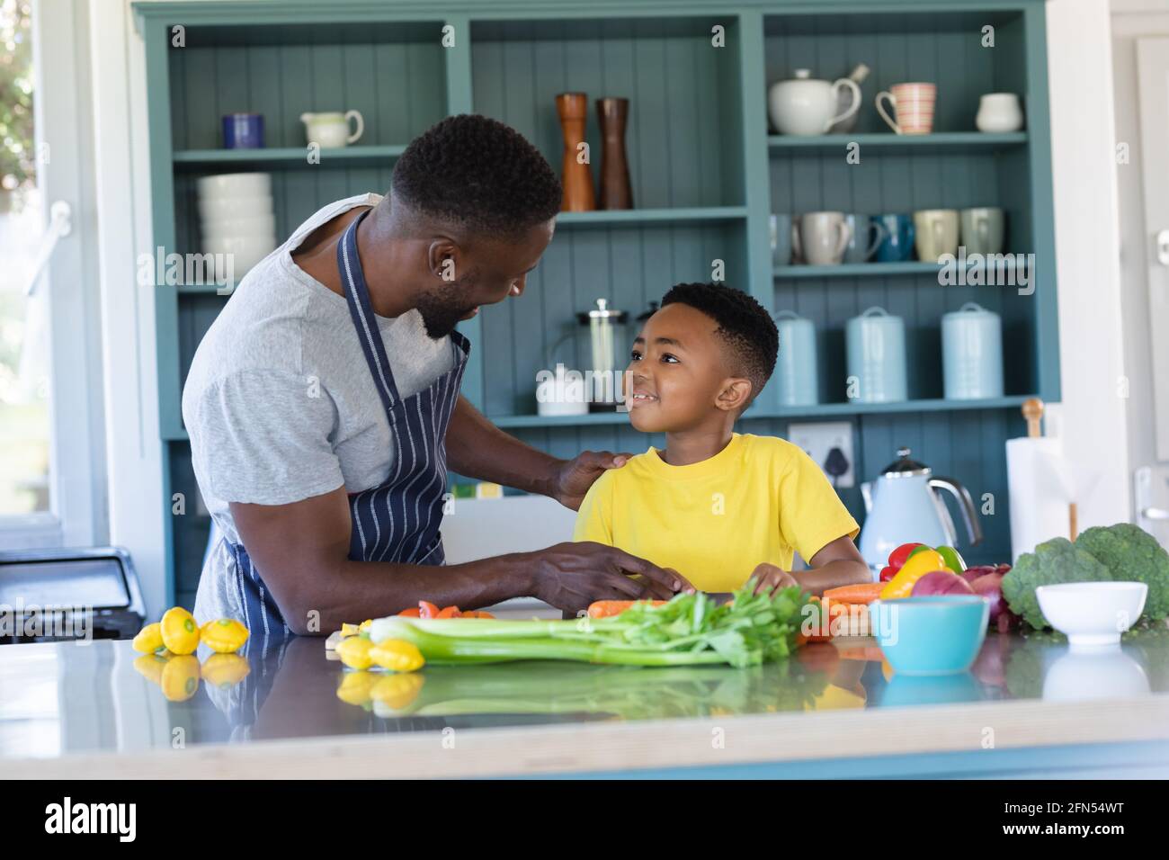 African american father and son in kitchen, cooking together Stock ...
