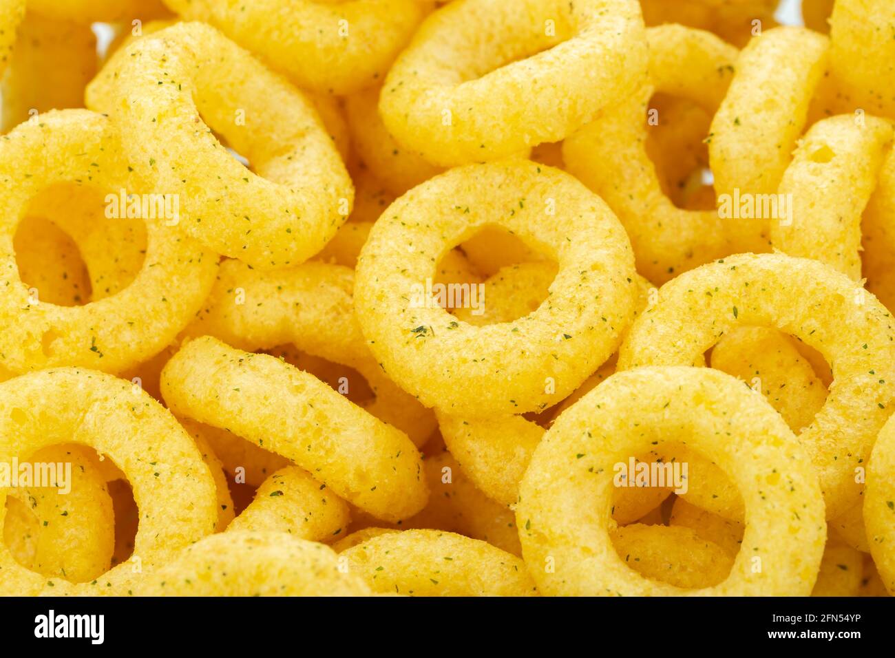 Beer snacks. Background of corn rings of sticks with cheese and green ...