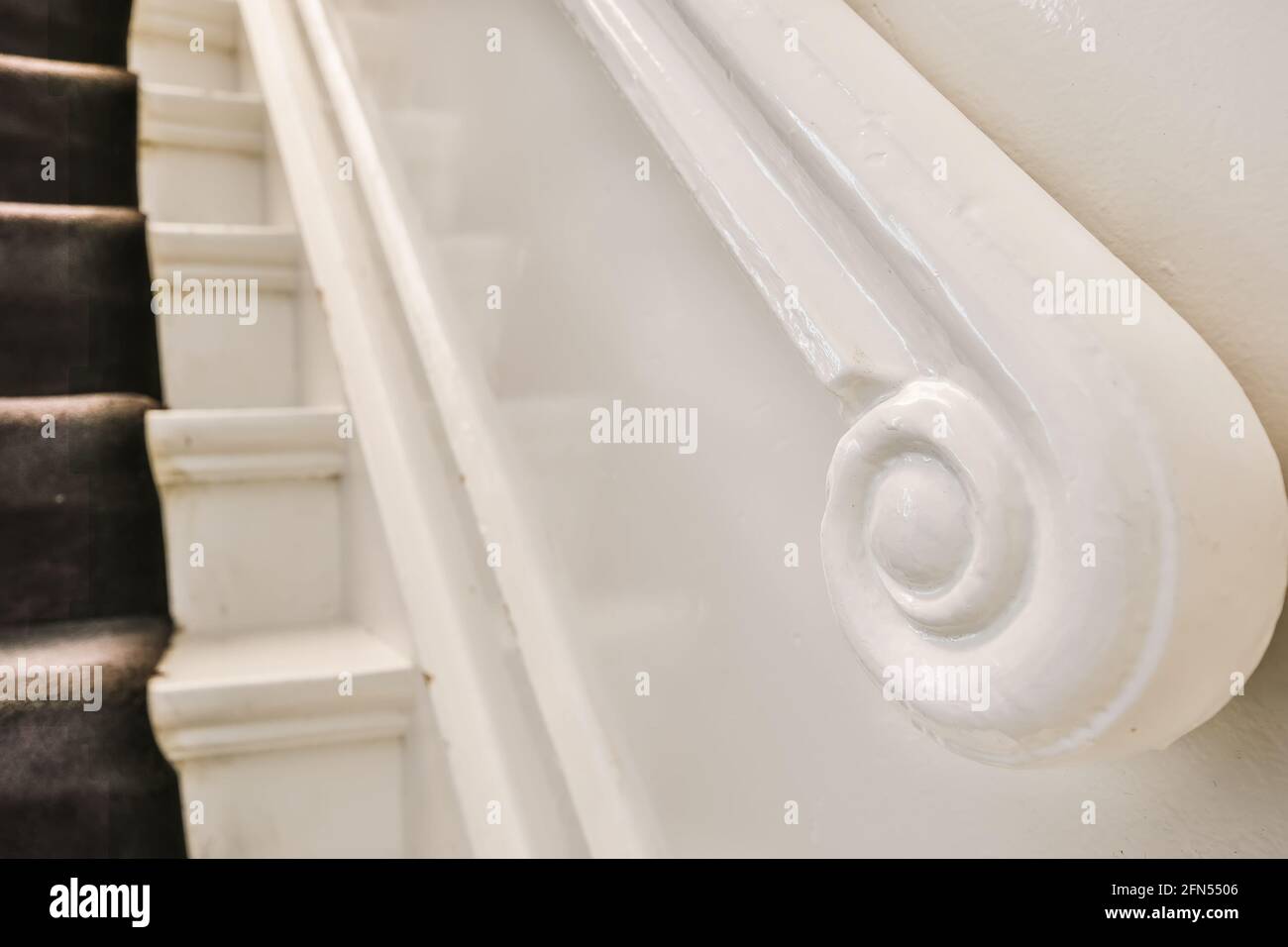 Handrail end scroll in white paint Stock Photo - Alamy