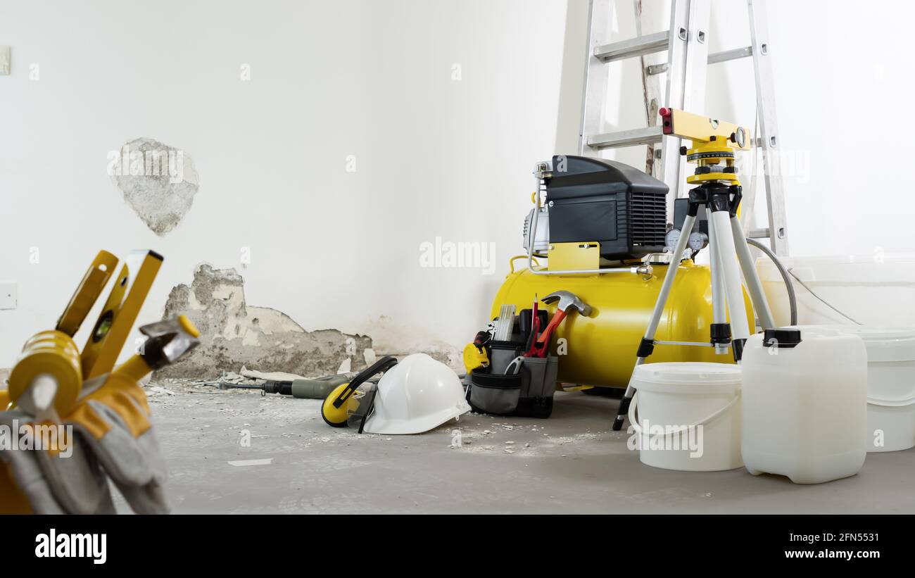 house renovation concept, helmet and safety headphones, air compressor ...
