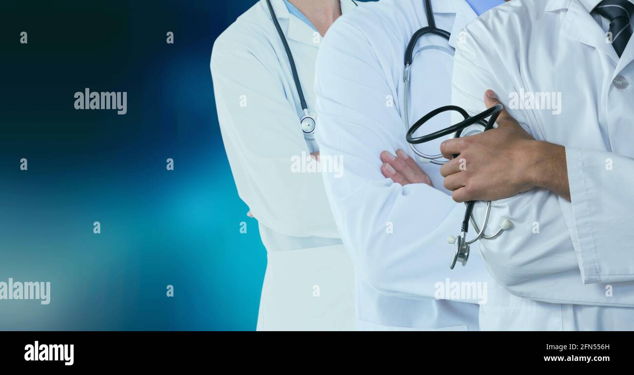 Mid section of team of doctors against hospital in background Stock ...