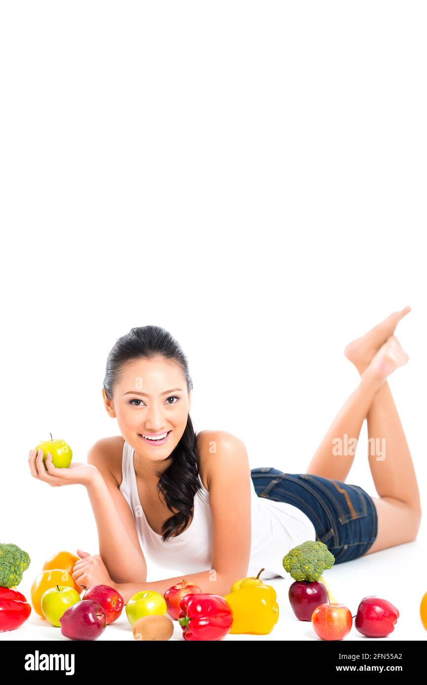 Asian Chinese woman eating fresh fruit Stock Photo - Alamy