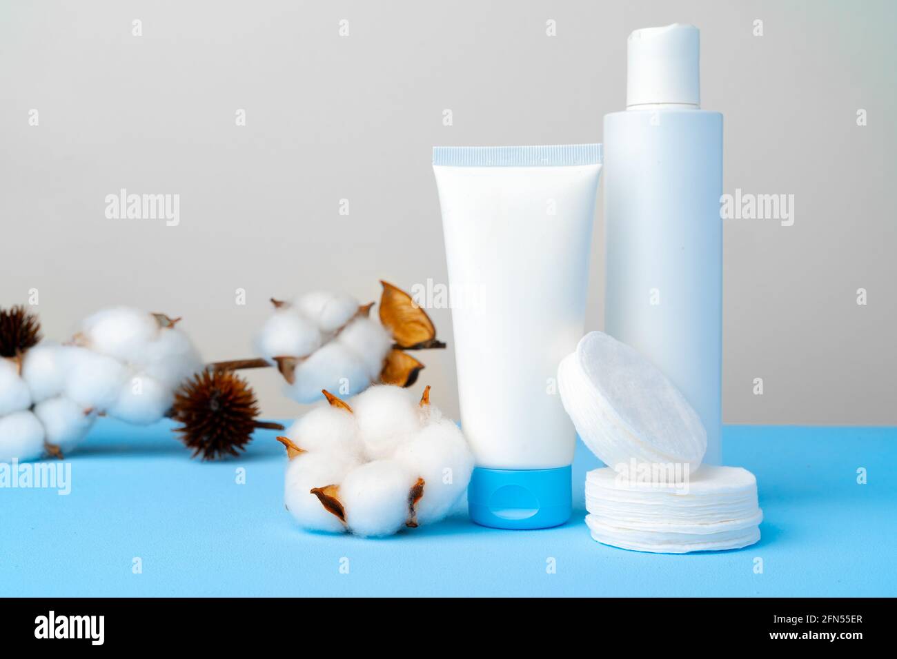 Cleansing gel and stack of cotton pads on paper background Stock Photo ...