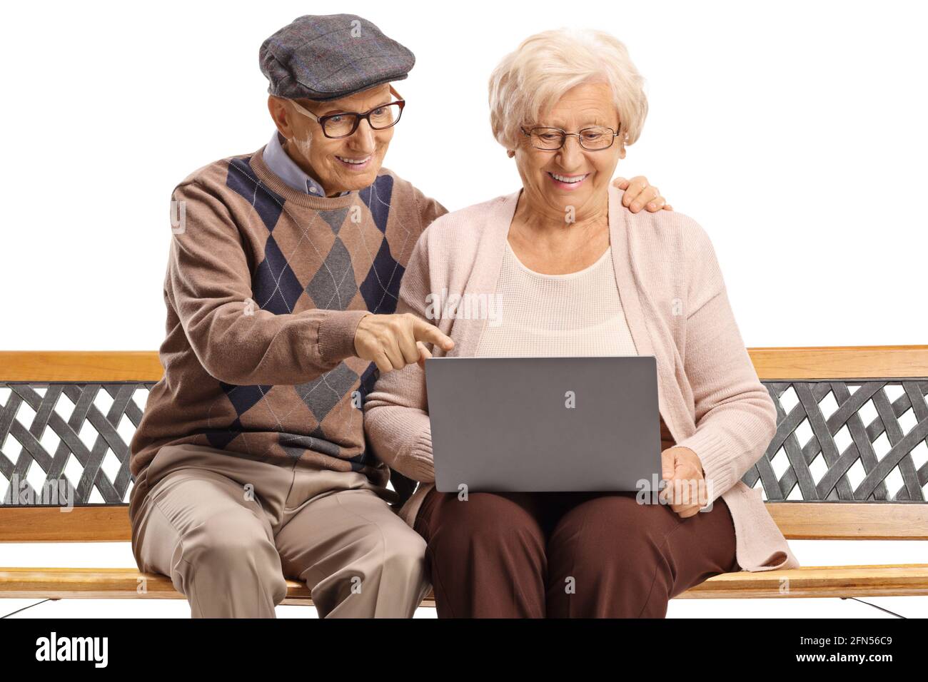 Elderly couple with a laptop computer sitting on a bench isolated on ...