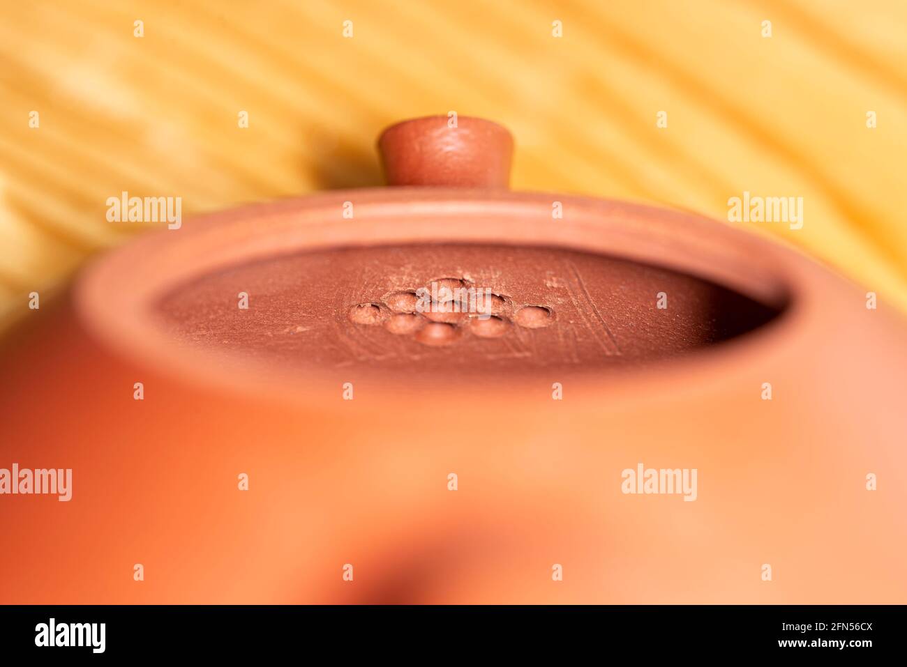 Holes in a Chinese teapot made of red Yixing clay, inside filter in the ...