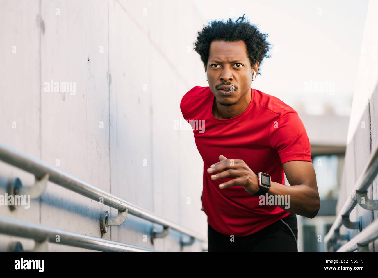 Athletic man running and doing exercise outdoors Stock Photo - Alamy