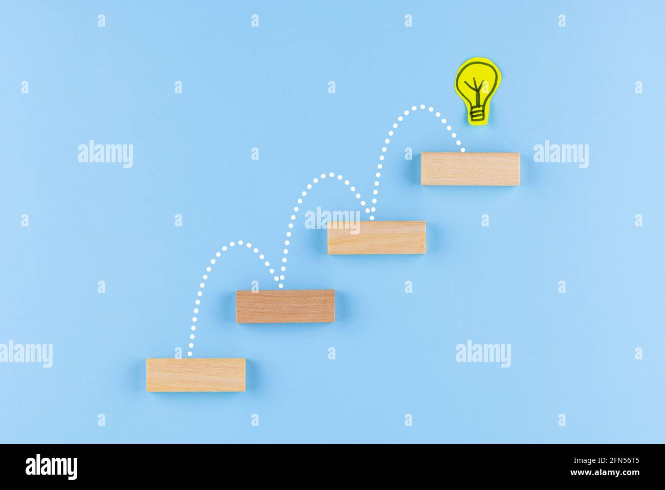 Wooden block stacking as step stair with white arrow up on blue ...