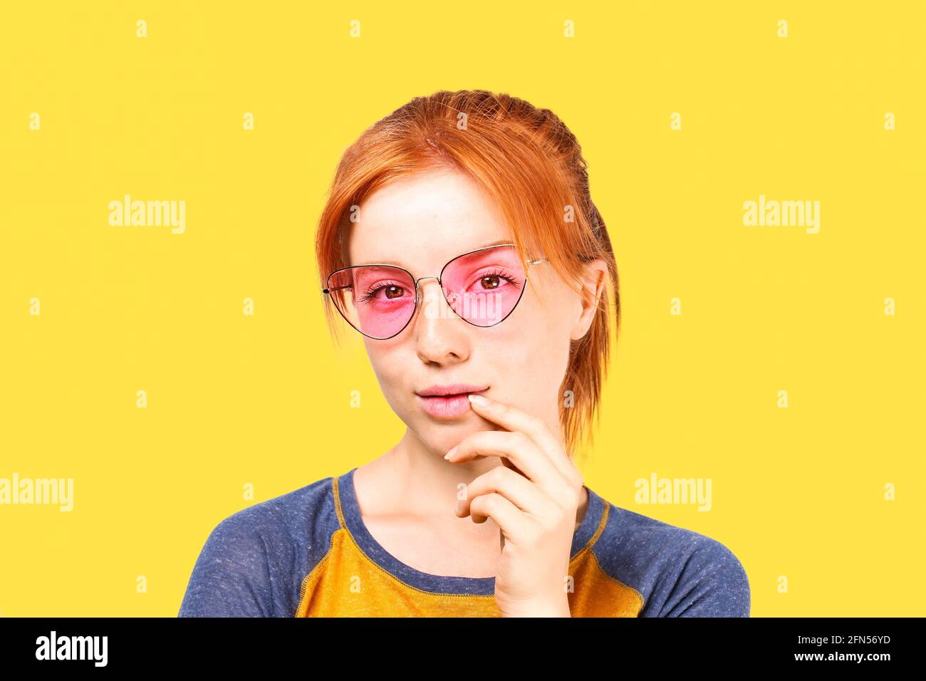 Attractive young woman with long red hair, wearing pink cat eye ...