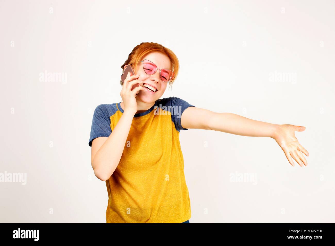 Young attractive natural redhead emotional woman talking on phone ...