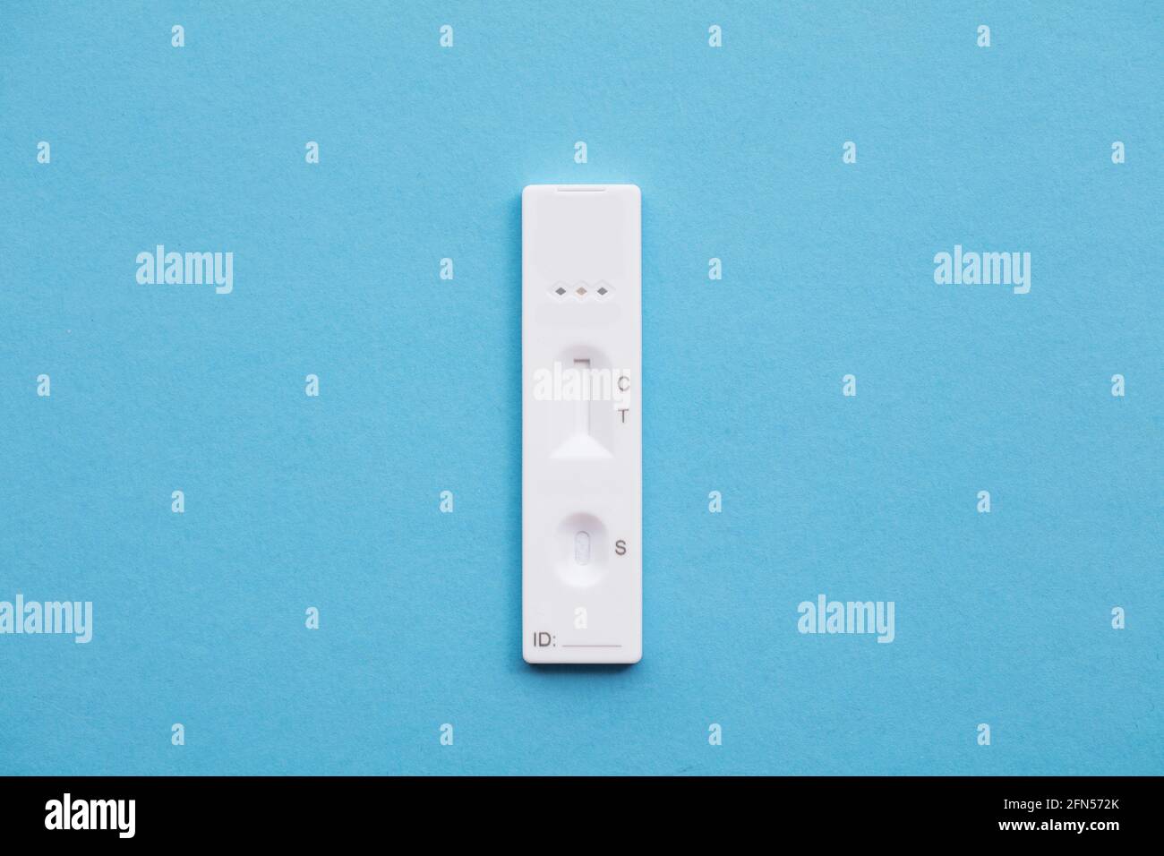 Coronavirus lateral flow home testing kit against a blue background ...