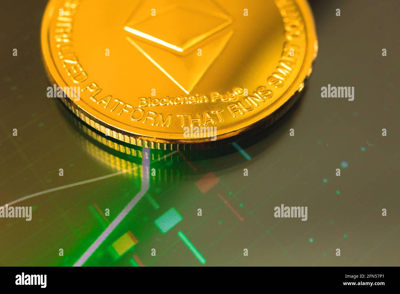 Golden ethereum ETH coin on stock chart background, exchange crypto ...