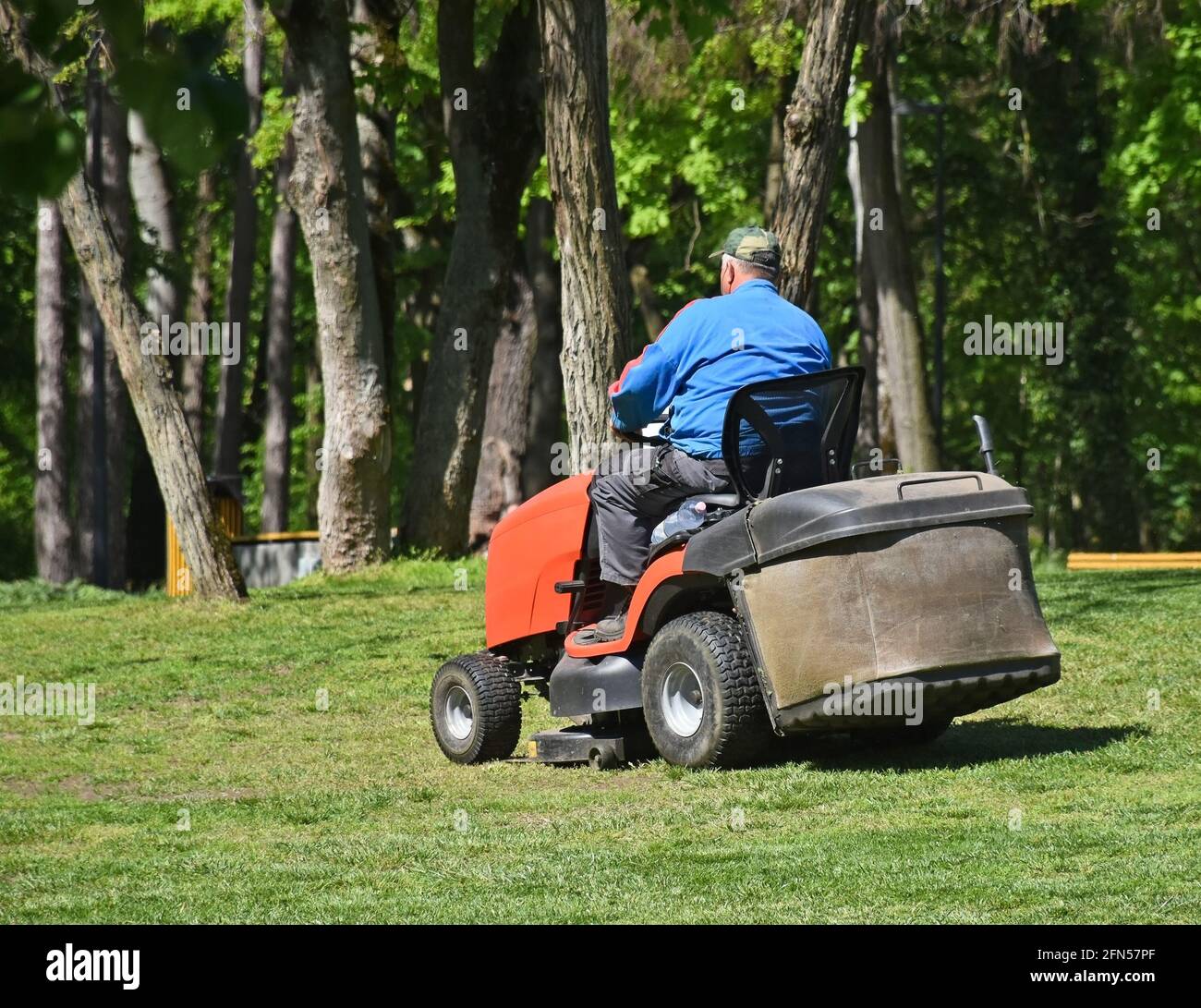 Lawn mower vehicle next to the woods Stock Photo - Alamy