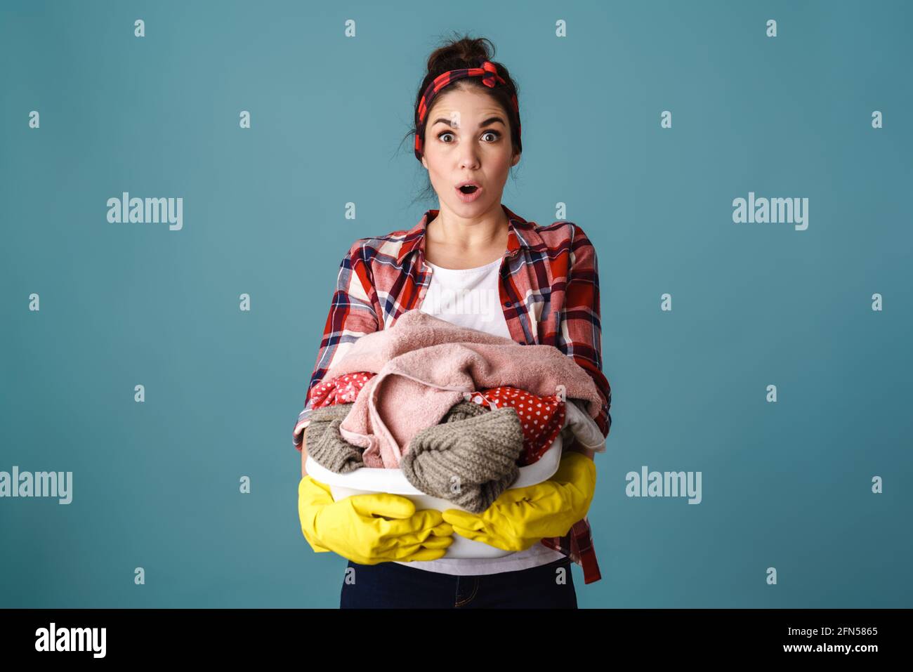 Shocked beautiful girl in girl posing with dirty clothes isolated over ...