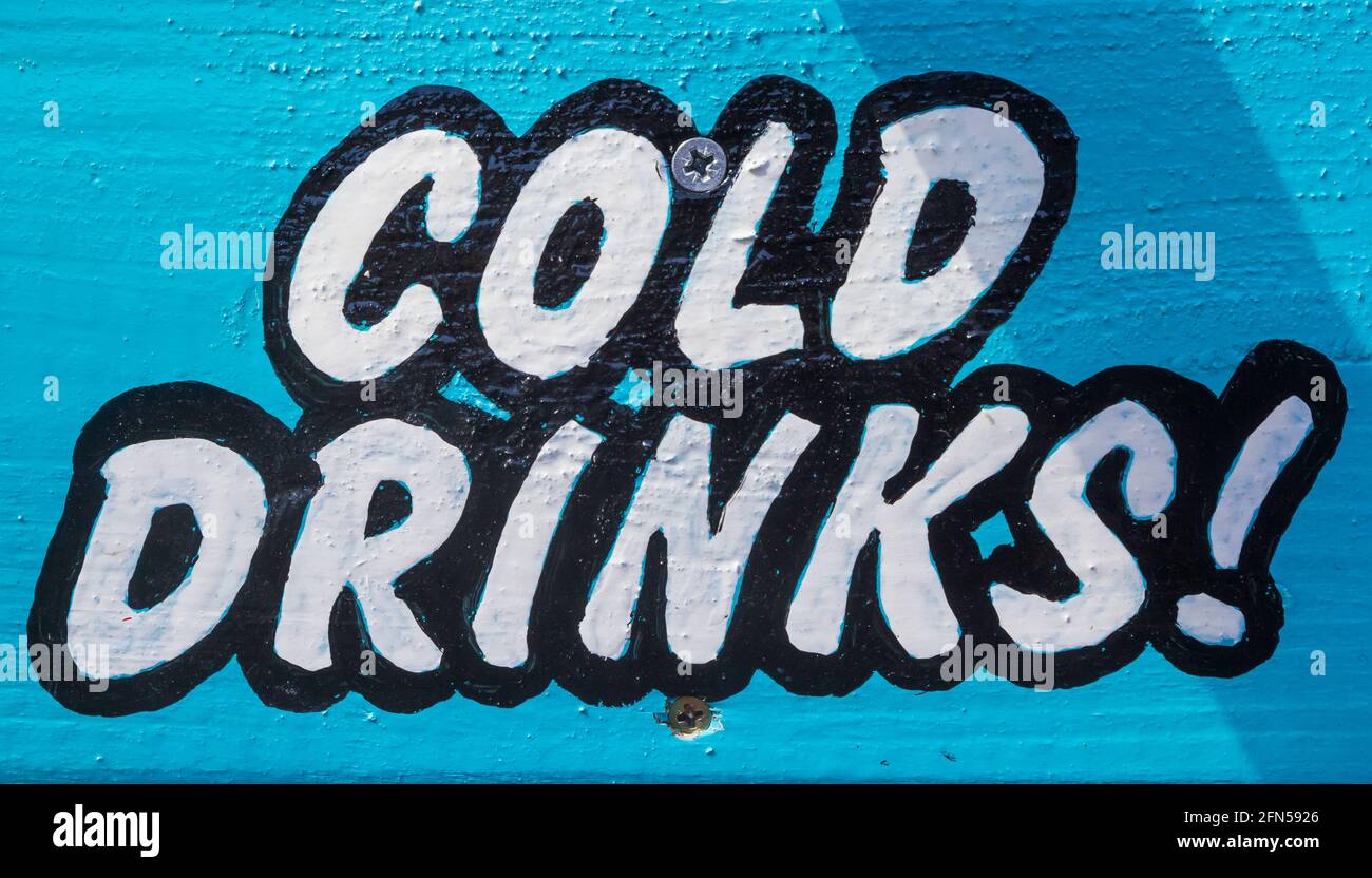 Blue painted wooden sign advertising cold drinks Stock Photo - Alamy